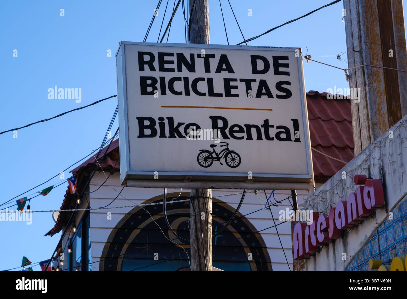Isla Holbox, Mexico – 12 February 2025: Sign promoting local bike rental services scattered ...