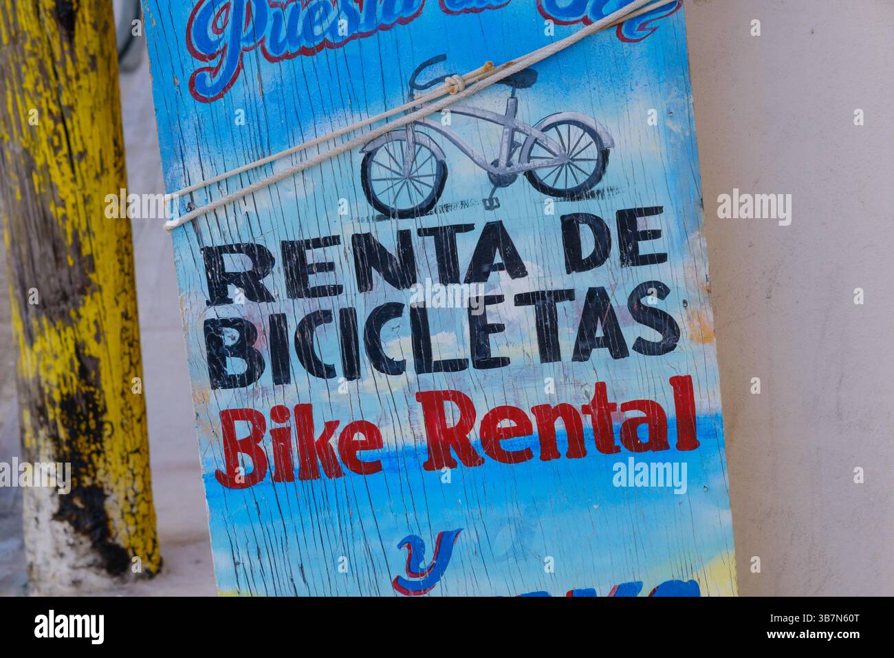 Isla Holbox, Mexico – 12 February 2025: Sign promoting local bike rental services scattered ...