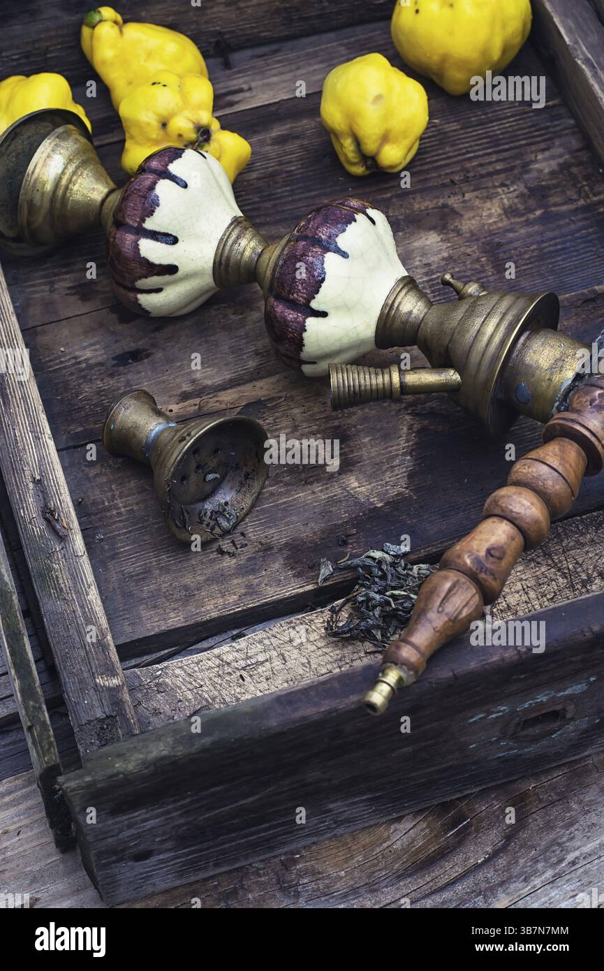Disassembled the hookah in wooden box with fresh fruit quince in a ...
