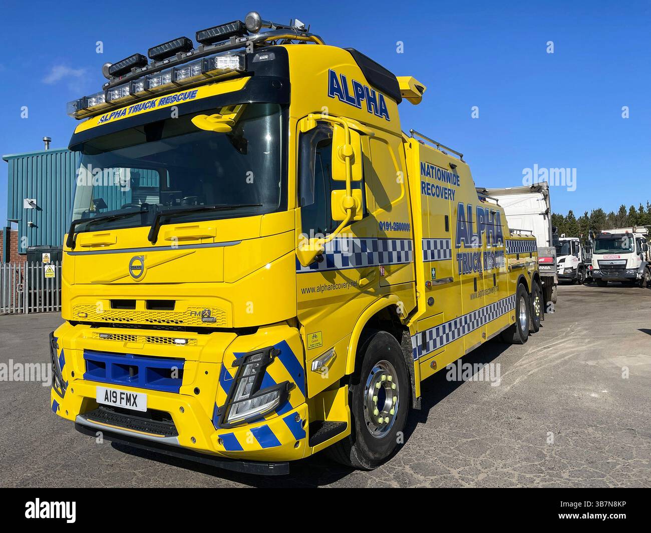 yellow Volvo recovery truck towing an HGV lorry behind - Alpha ...