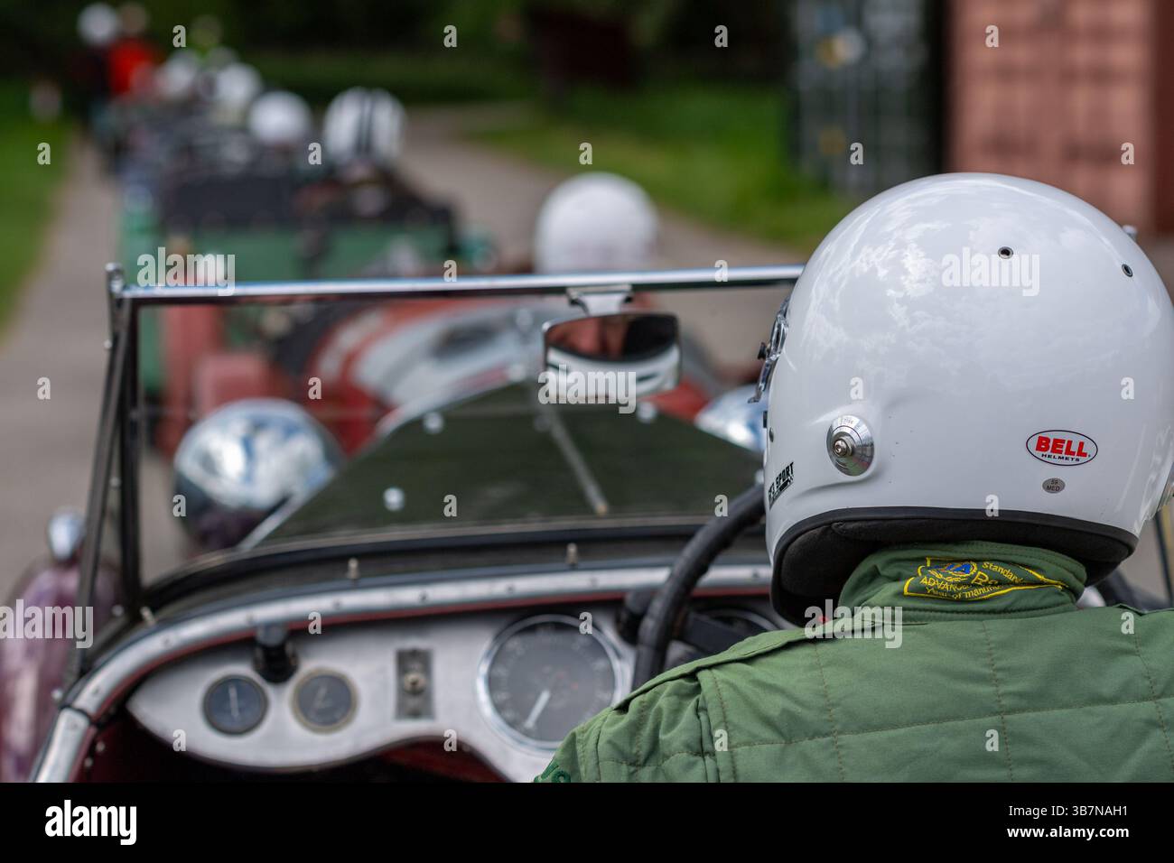 Drivers lining up ready to start at a VSCC motor racing event wearing ...