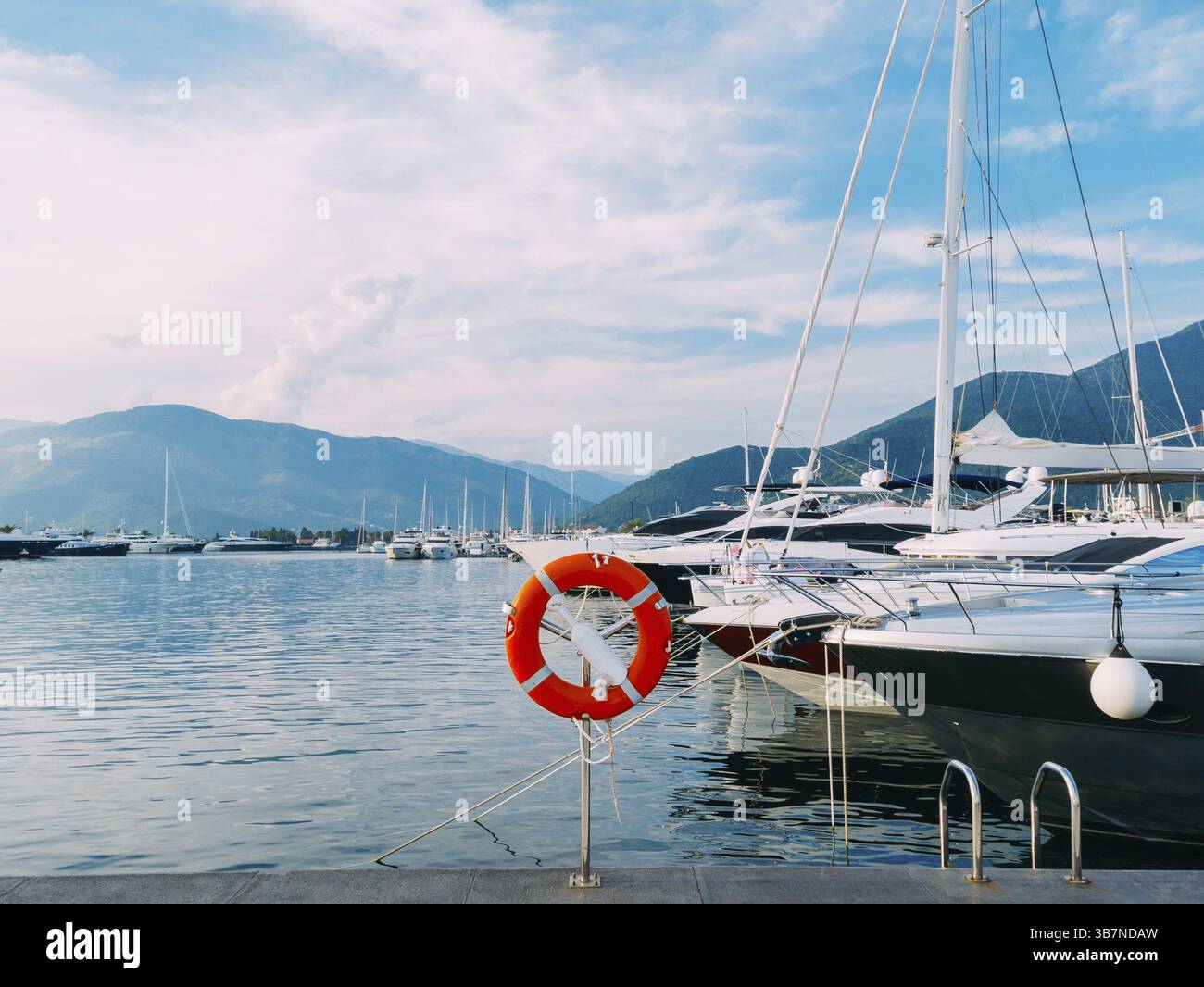 Lifebuoy in the marina for yachts. Red circle on the boat dock. Porto ...