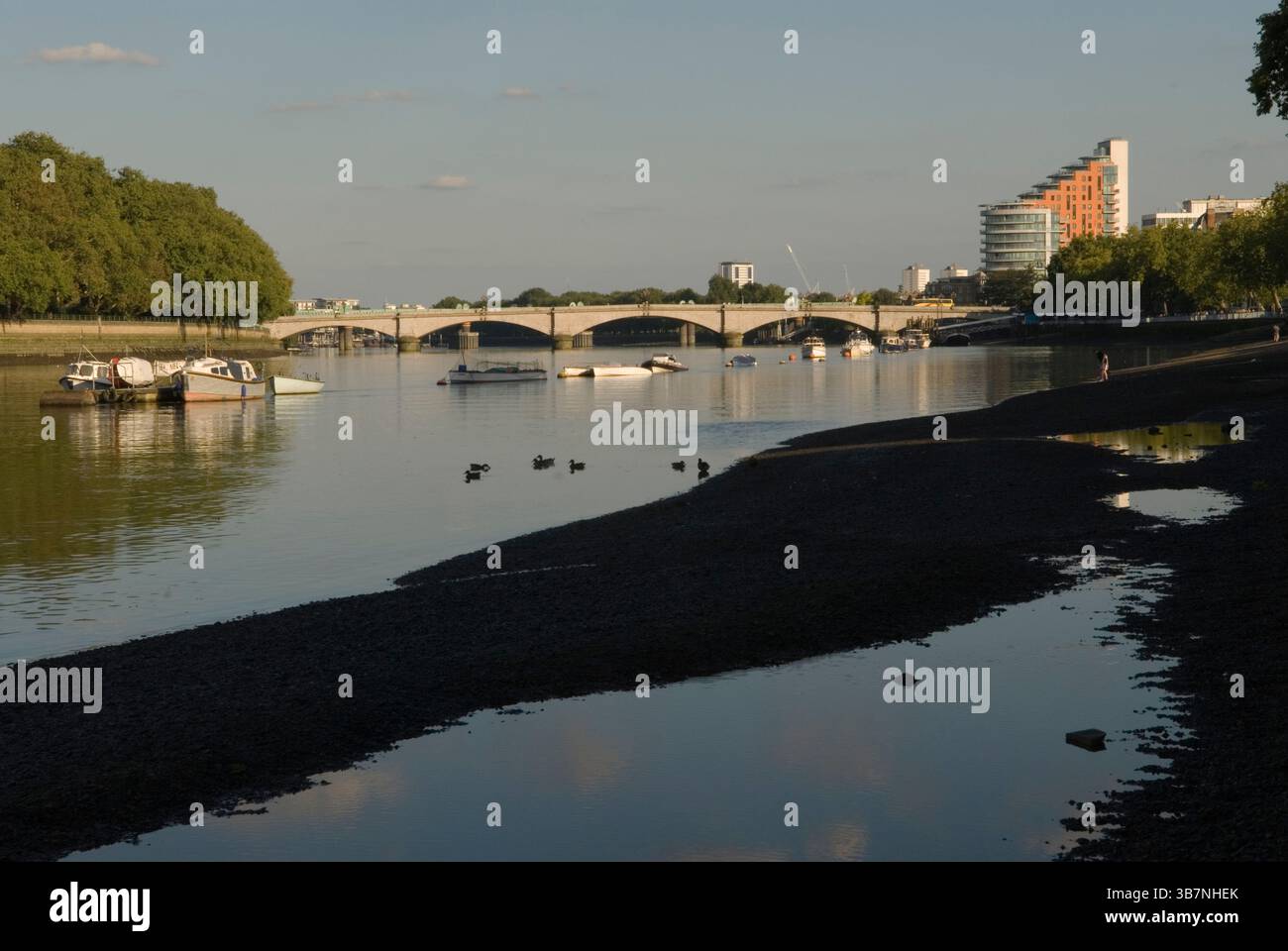 Low tide River Thames at Putney. Putney Bridge and Putney Wharf Tower ...