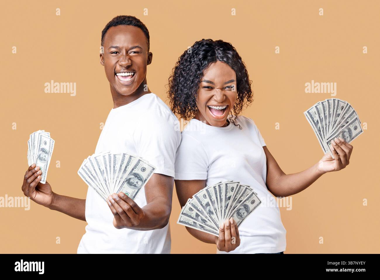 Emotional black couple dancing with bunch of money banknotes Stock ...