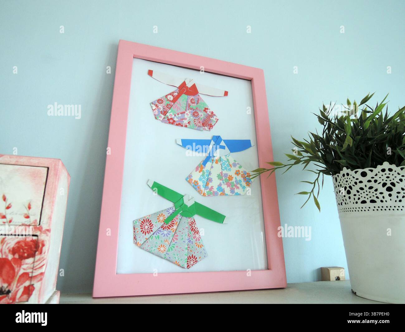 Hanbok handmade origami craft artwork set into a pink picture frame as ...