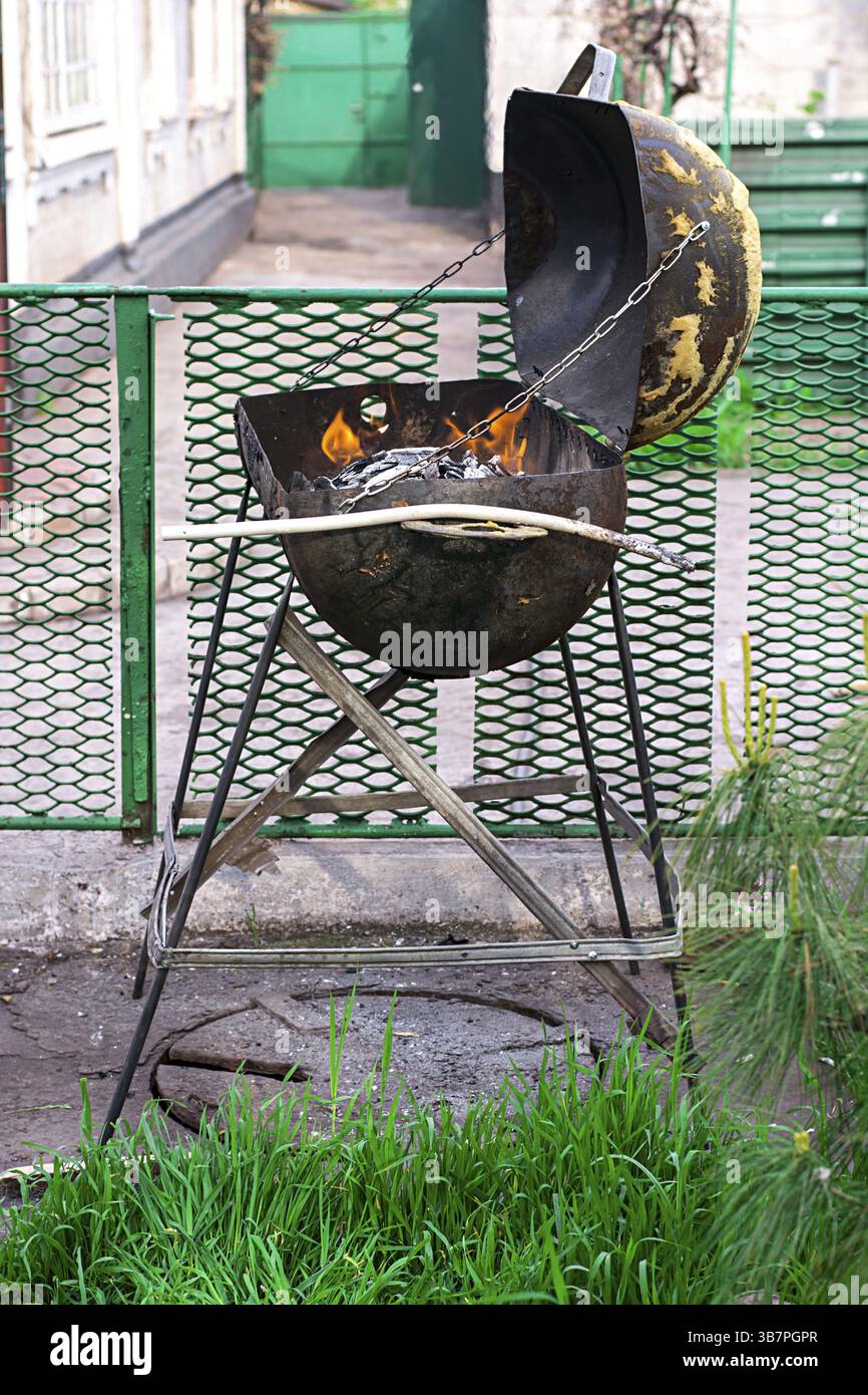Improvised brazier with burning wood in it Stock Photo - Alamy