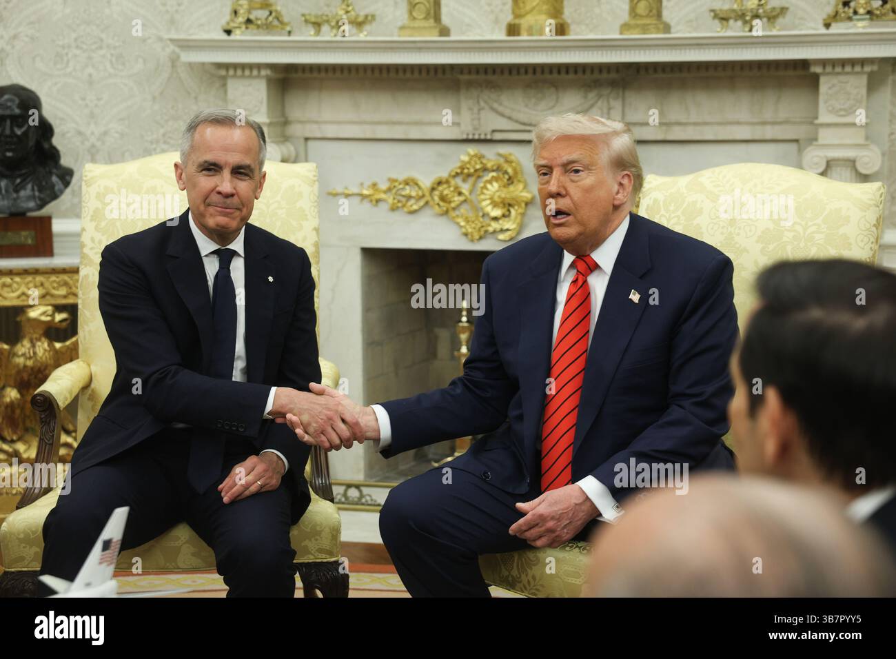 Prime Minister Mark Carney of Canada shakes hands with US President ...