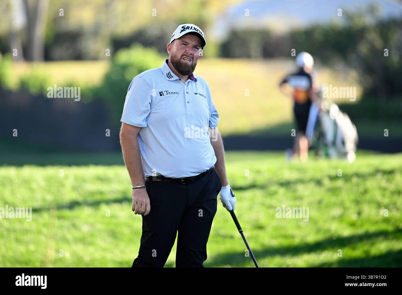 Shane Lowry, of Ireland, reacts after hitting his tee shot on the 18th ...