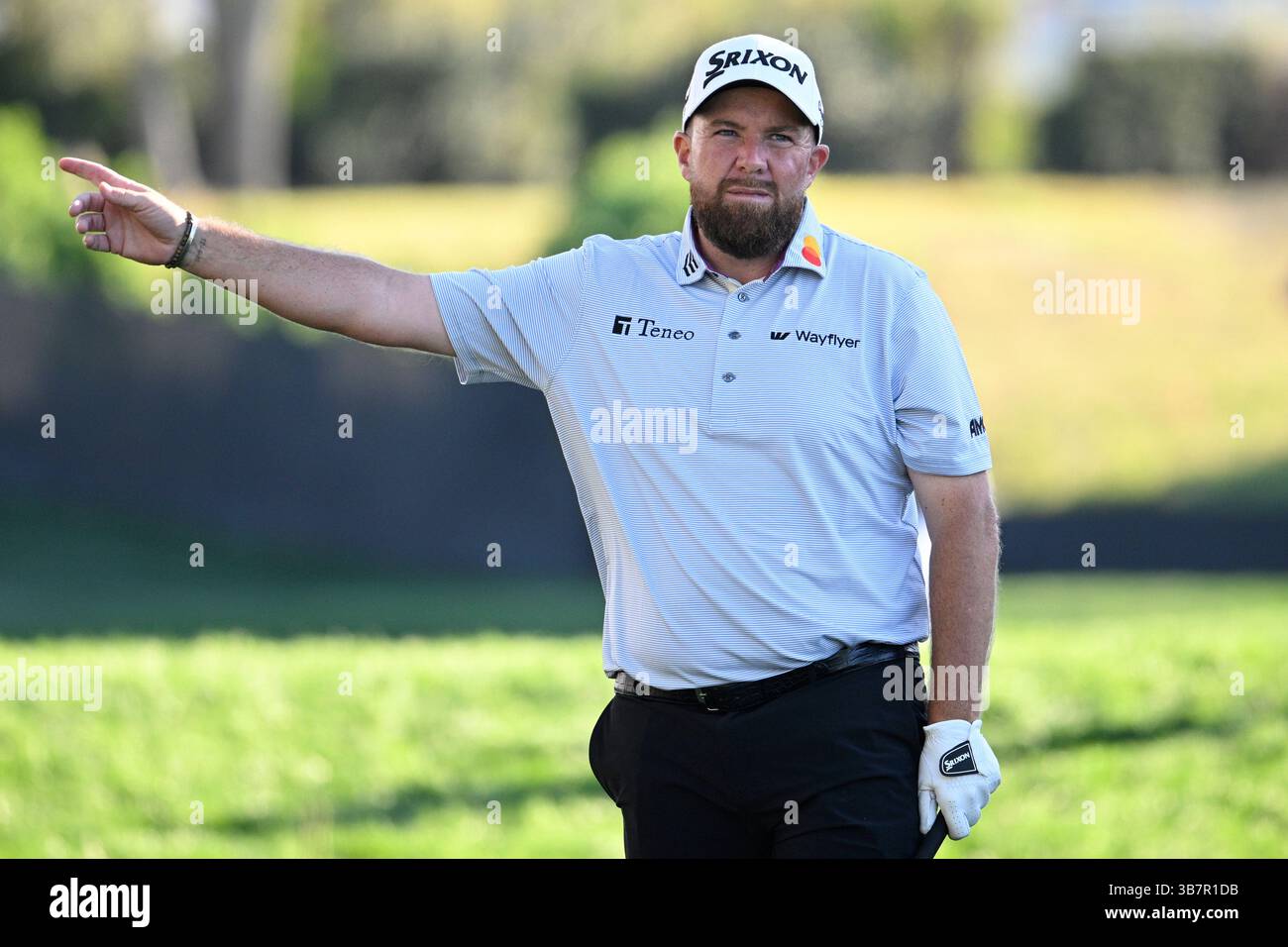 Shane Lowry, of Ireland, reacts after hitting his tee shot on the 18th ...