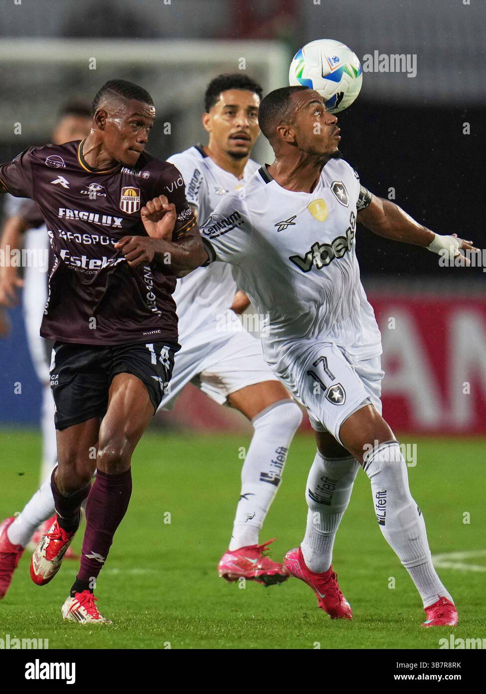 Marlon Freitas of Brazil's Botafogo heads the ball challenged by ...