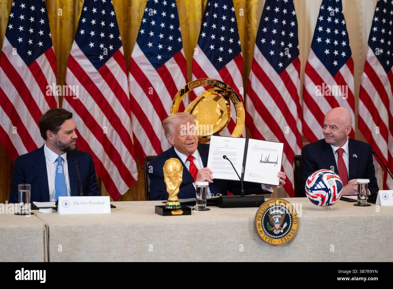 President Donald Trump holds up the charter of the White House Task ...