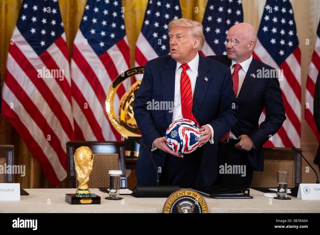 President Donald Trump holds a soccer ball as he and FIFA President ...