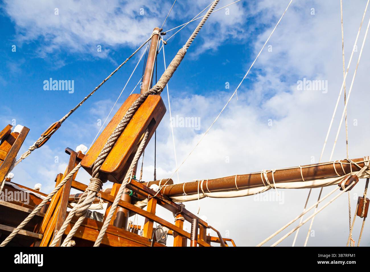 Traditional wooden sailing ship. Part of an old wooden ship with ropes ...