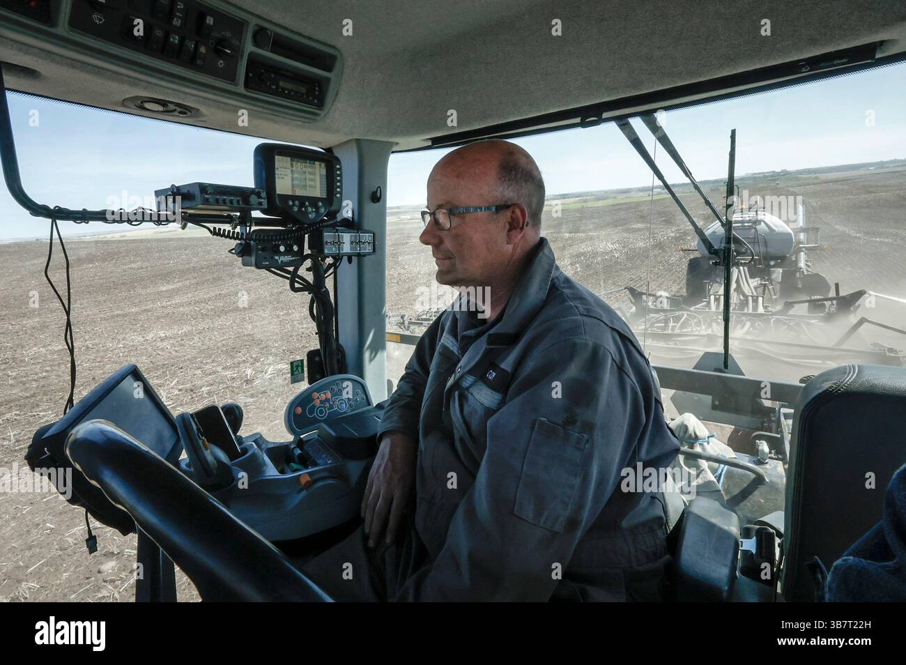 Cremona, Canada. 06th May, 2025. David Reid drives a seeding rig as he ...