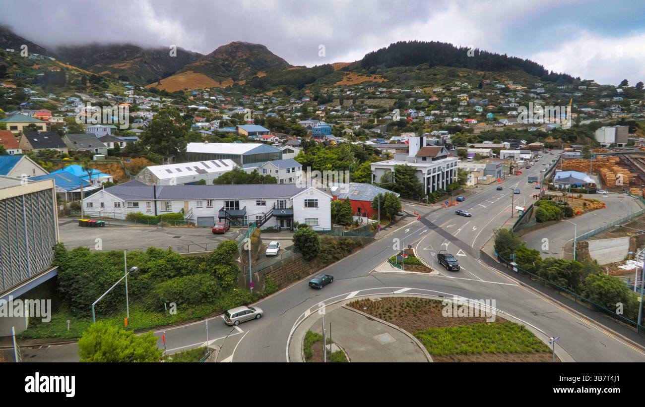 Road intersection at Lyttelton port NZ with houses on hillside Stock ...
