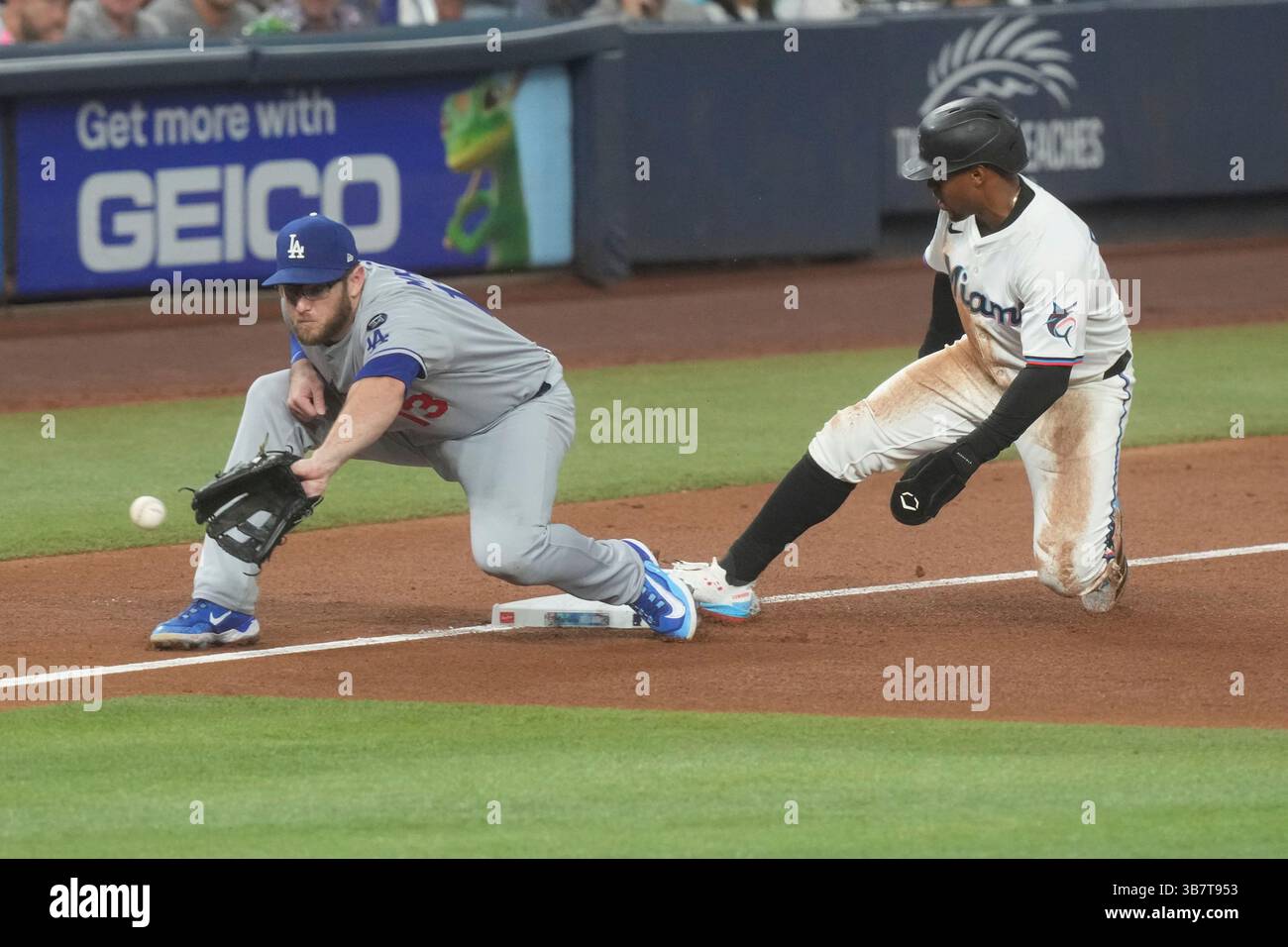 Miami Marlins' Xavier Edwards is safe on third base as Los Angeles ...