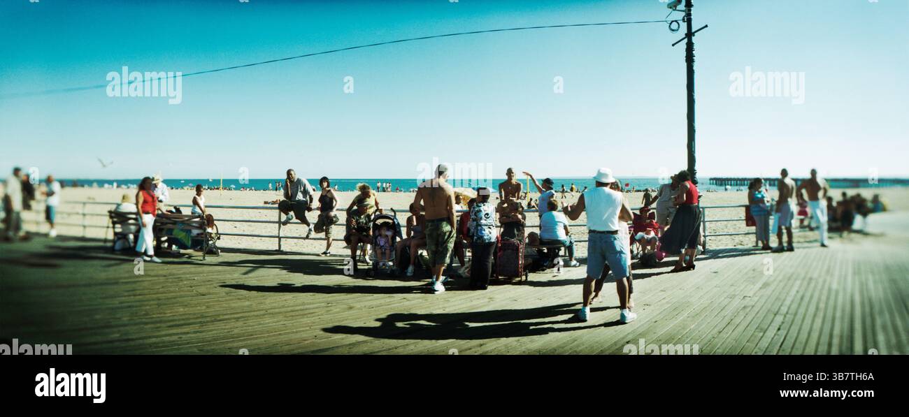 Panoramic view of tourists on a boardwalk, Coney Island Boardwalk ...