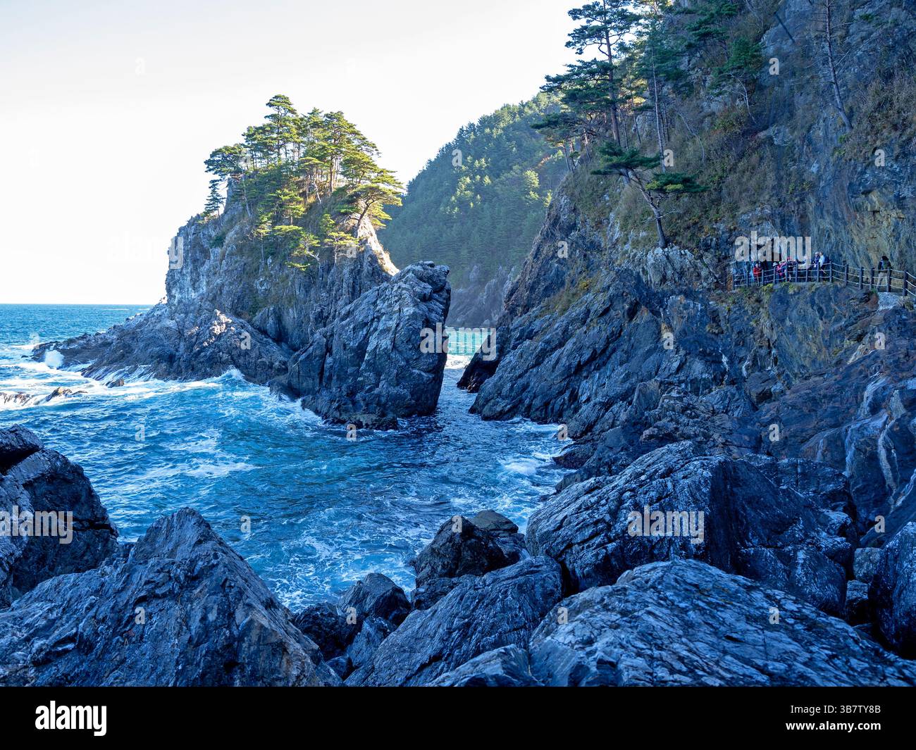 Group of hikers on a cliffside section of the Michinoku Coastal Trail ...