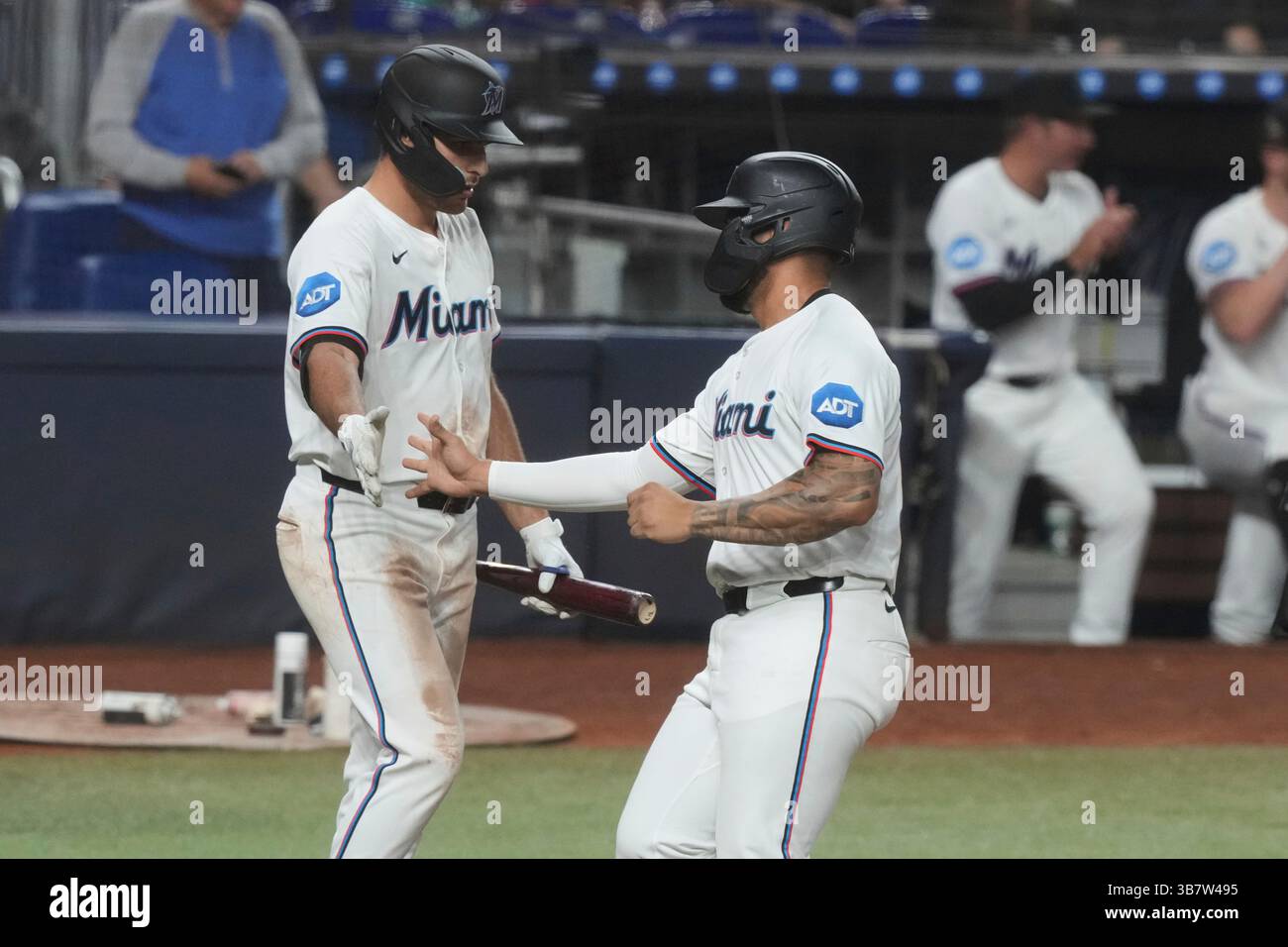 Miami Marlins' Agustín Ramírez, right, scores on a double by Connor ...