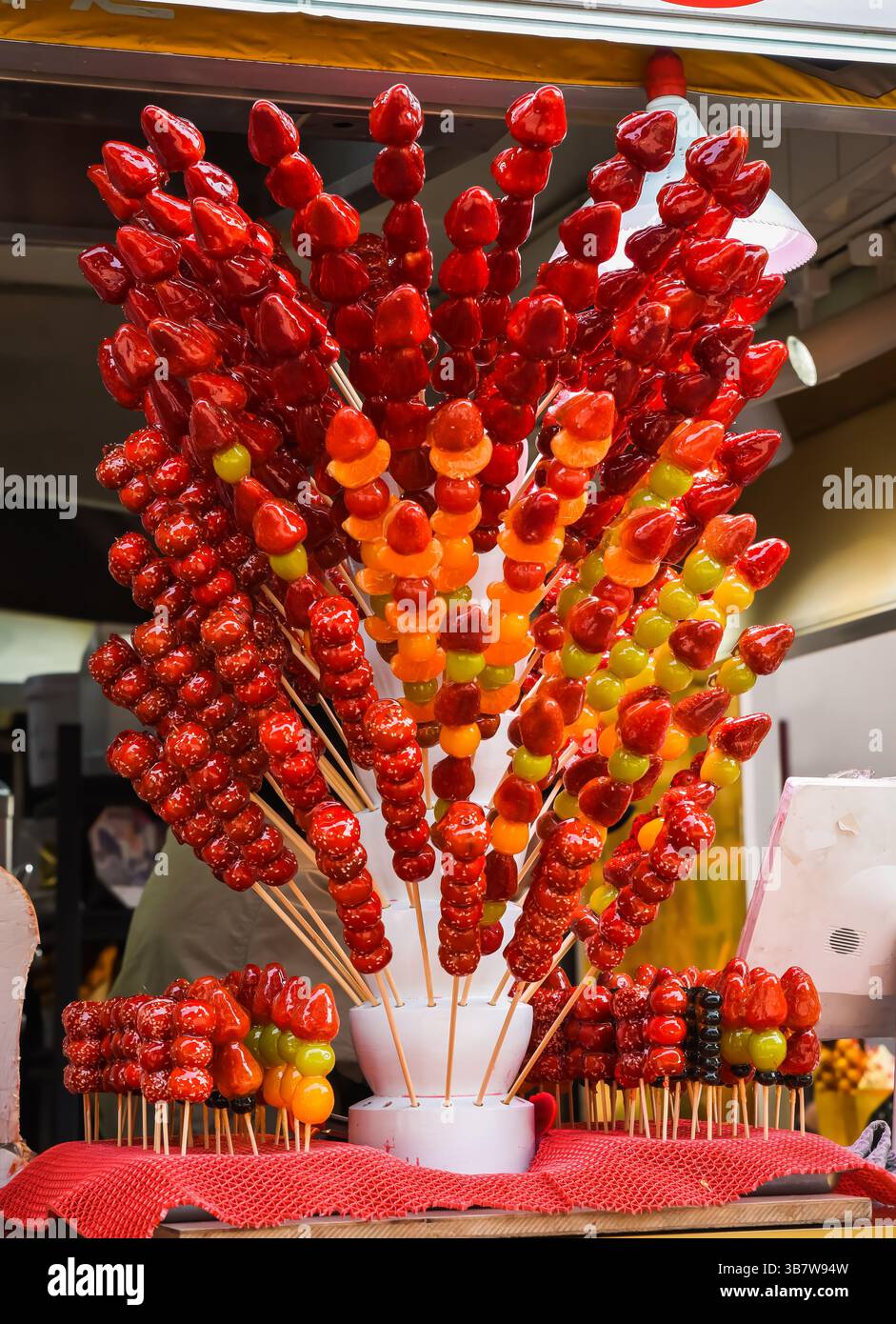 Candied fruits on sticks at a street food stall in Shanghai, on ...