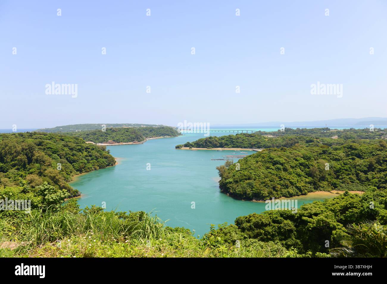 A picturesque scene of a coastal lagoon surrounded by lush vegetation ...