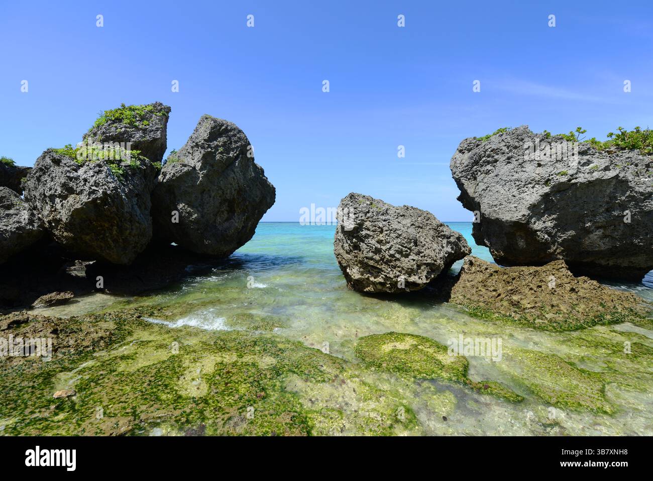 Beautiful rock formations in the water at Nirai Beach in Okinawa, Japan ...