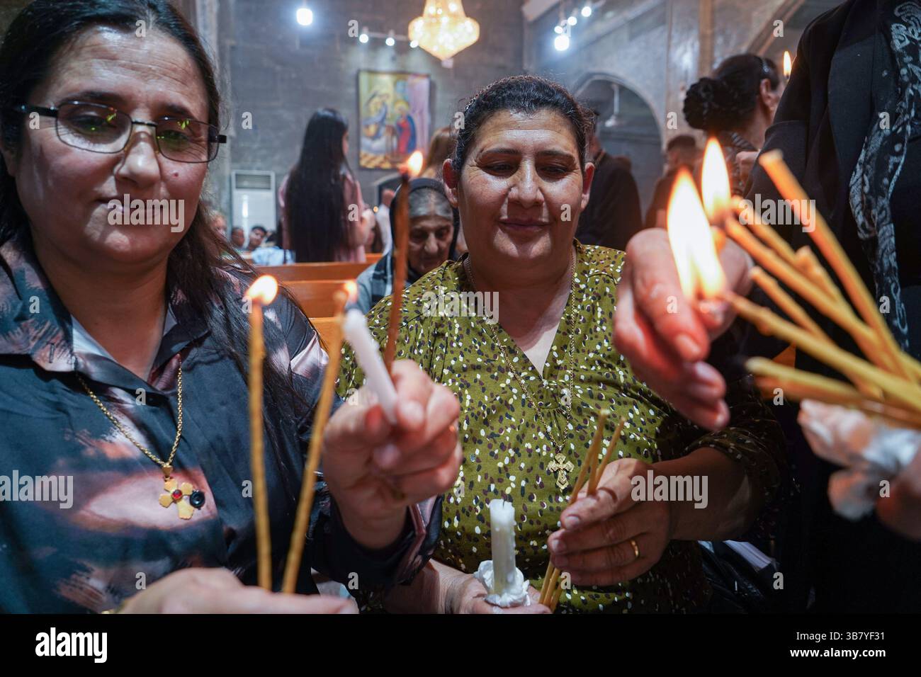 May 5, 2024, Nineveh, Iraq: Syriac Orthodox Christian women hold lit ...