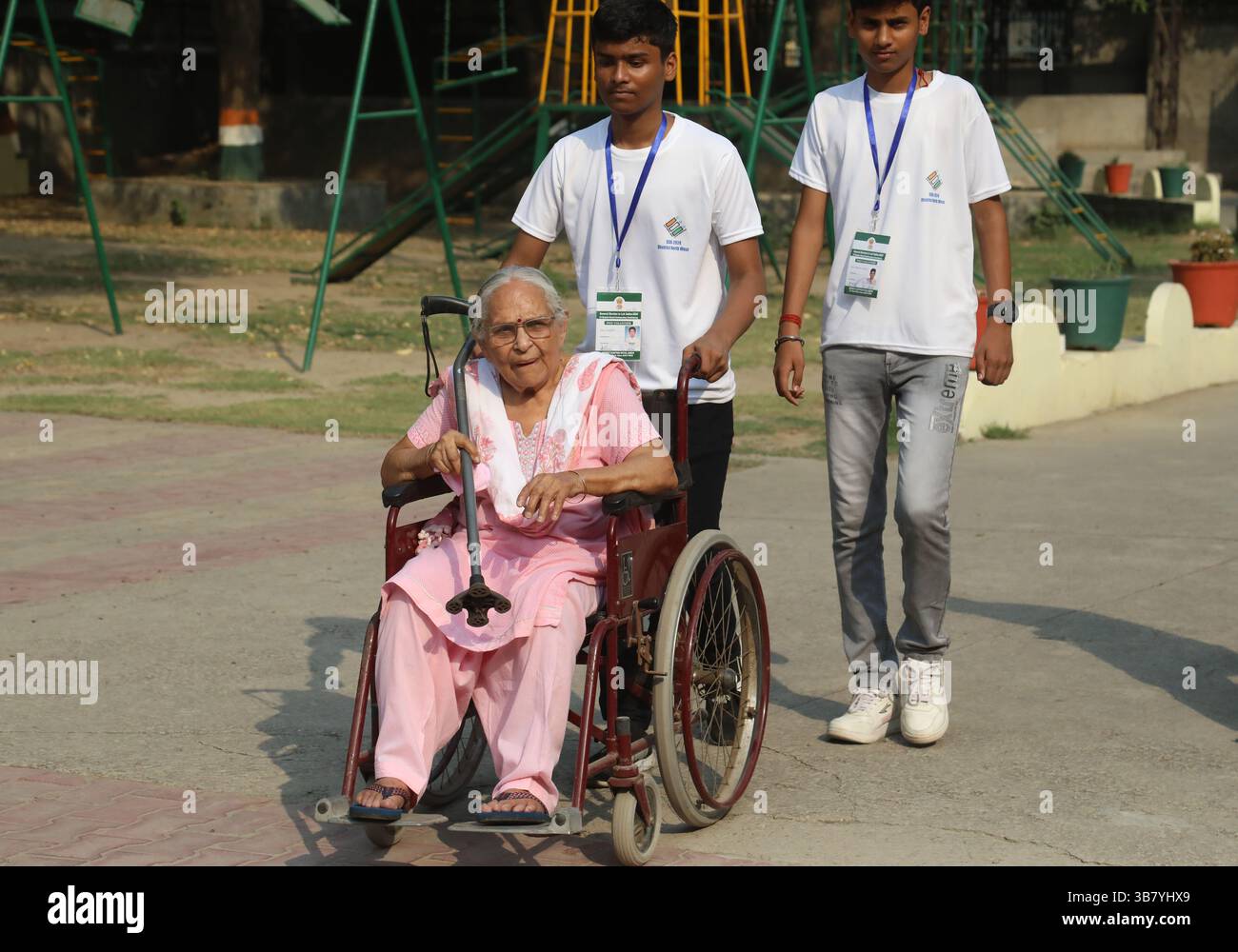 May 25, 2024, New Delhi, India: An elderly woman being helped by PWD ...