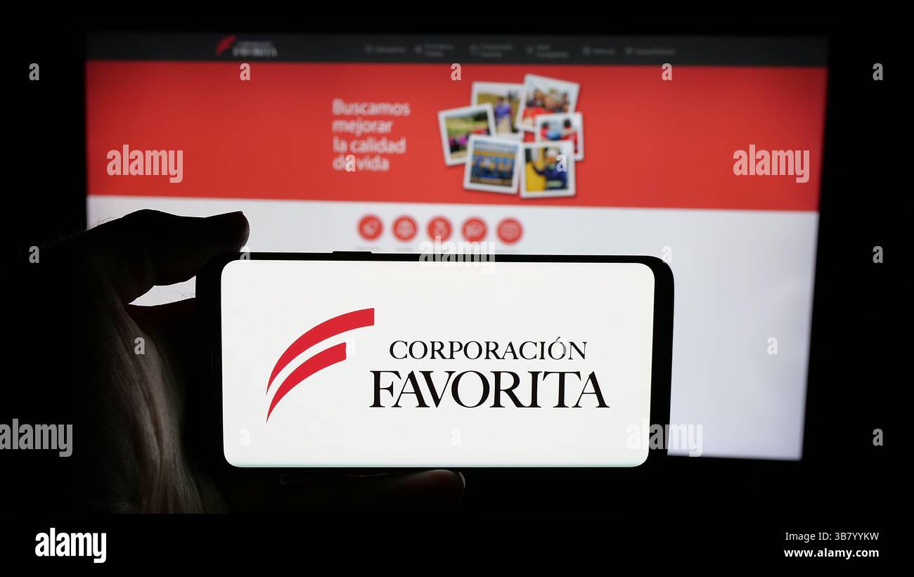 In this photo illustration, a person is holding a cellphone with the logo of retail company ...