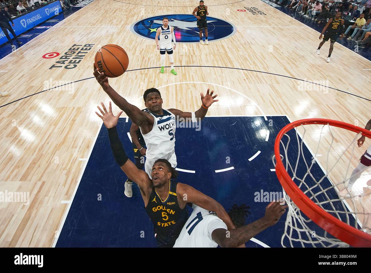Minnesota Timberwolves guard Anthony Edwards, top, grabs a rebound as ...