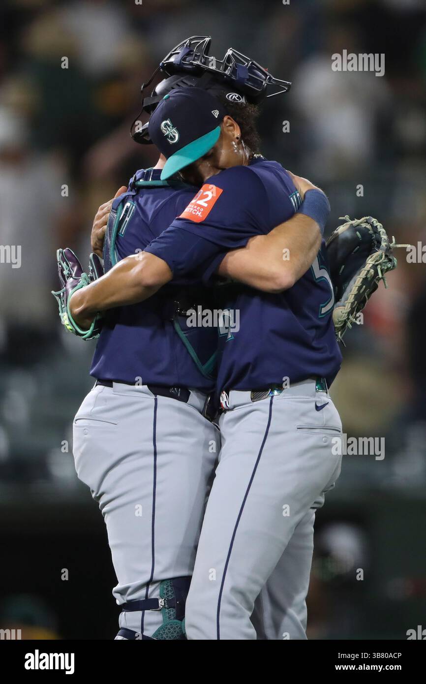 Seattle Mariners catcher Cal Raleigh, left, and pitcher Carlos Vargas ...
