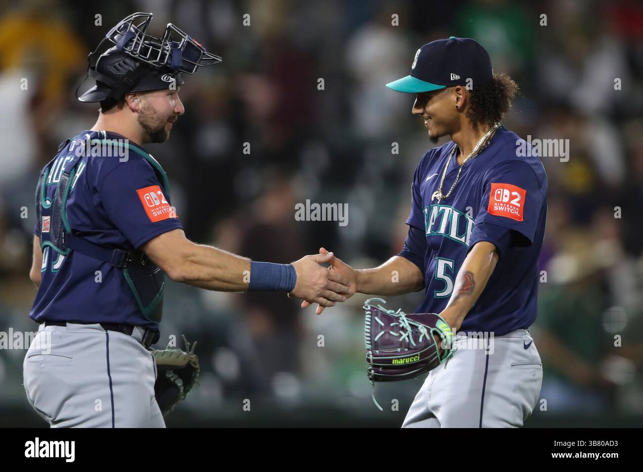 Seattle Mariners catcher Cal Raleigh, left, and pitcher Carlos Vargas ...