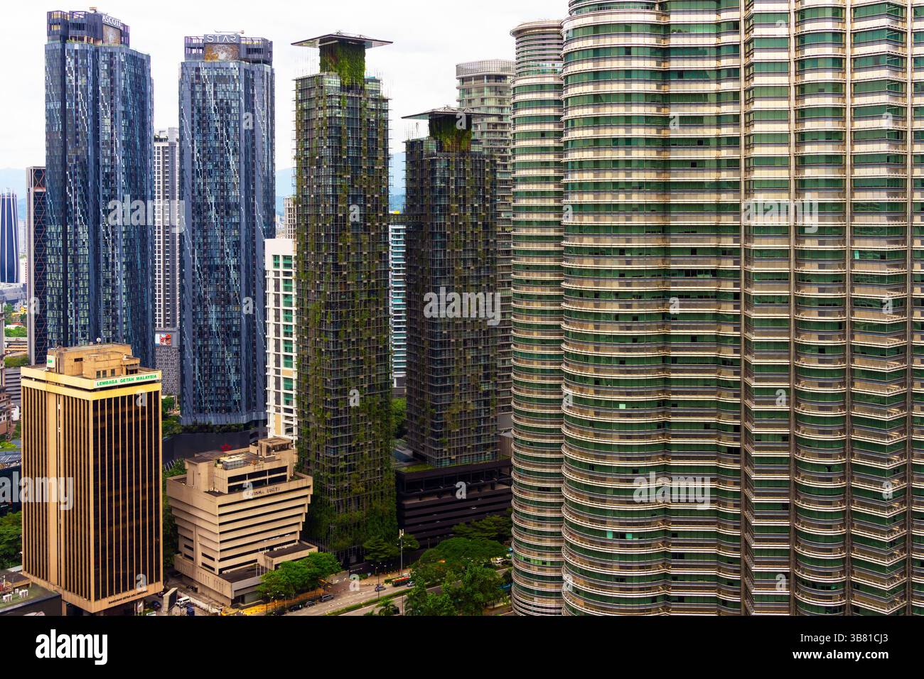 Le Nouvel towers covered with climbers and Petronas Towers, Kuala ...