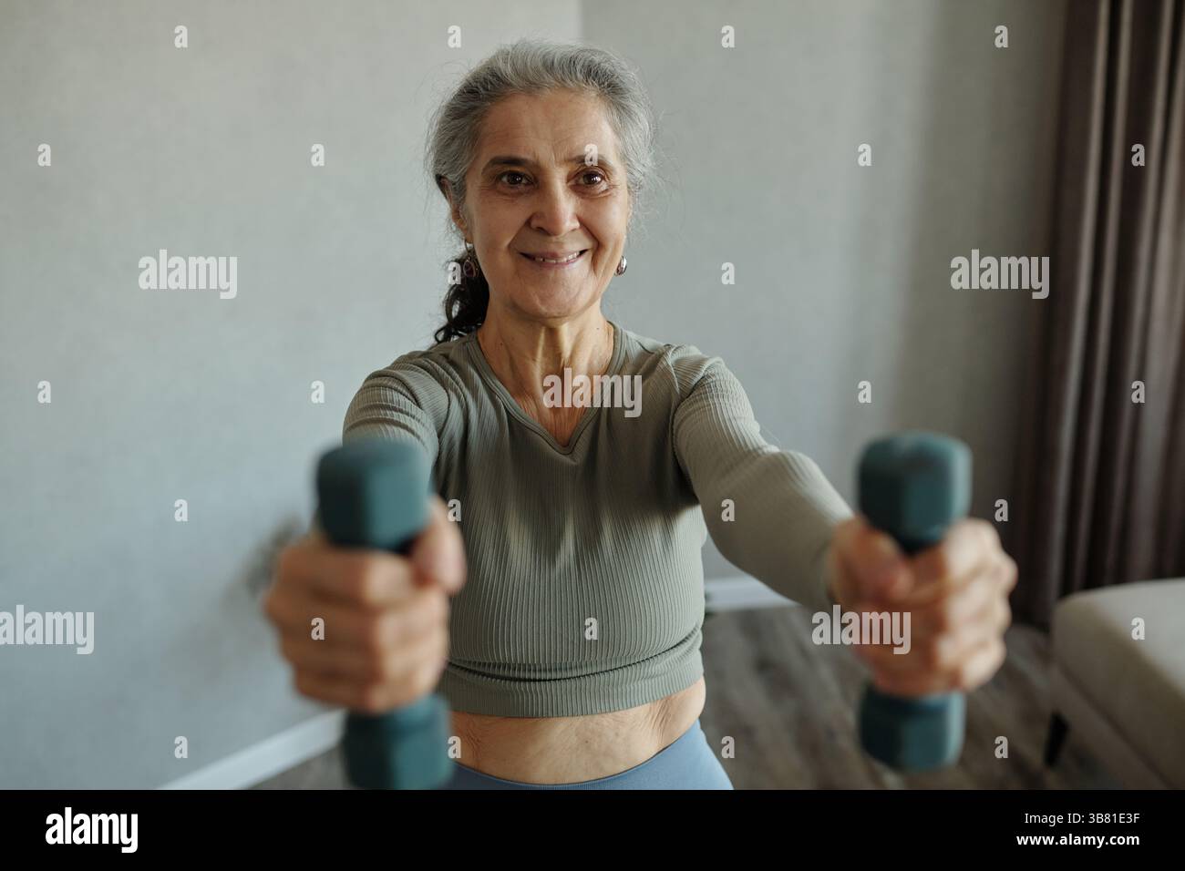 Mature woman lifting dumbbells senior hi-res stock photography and ...