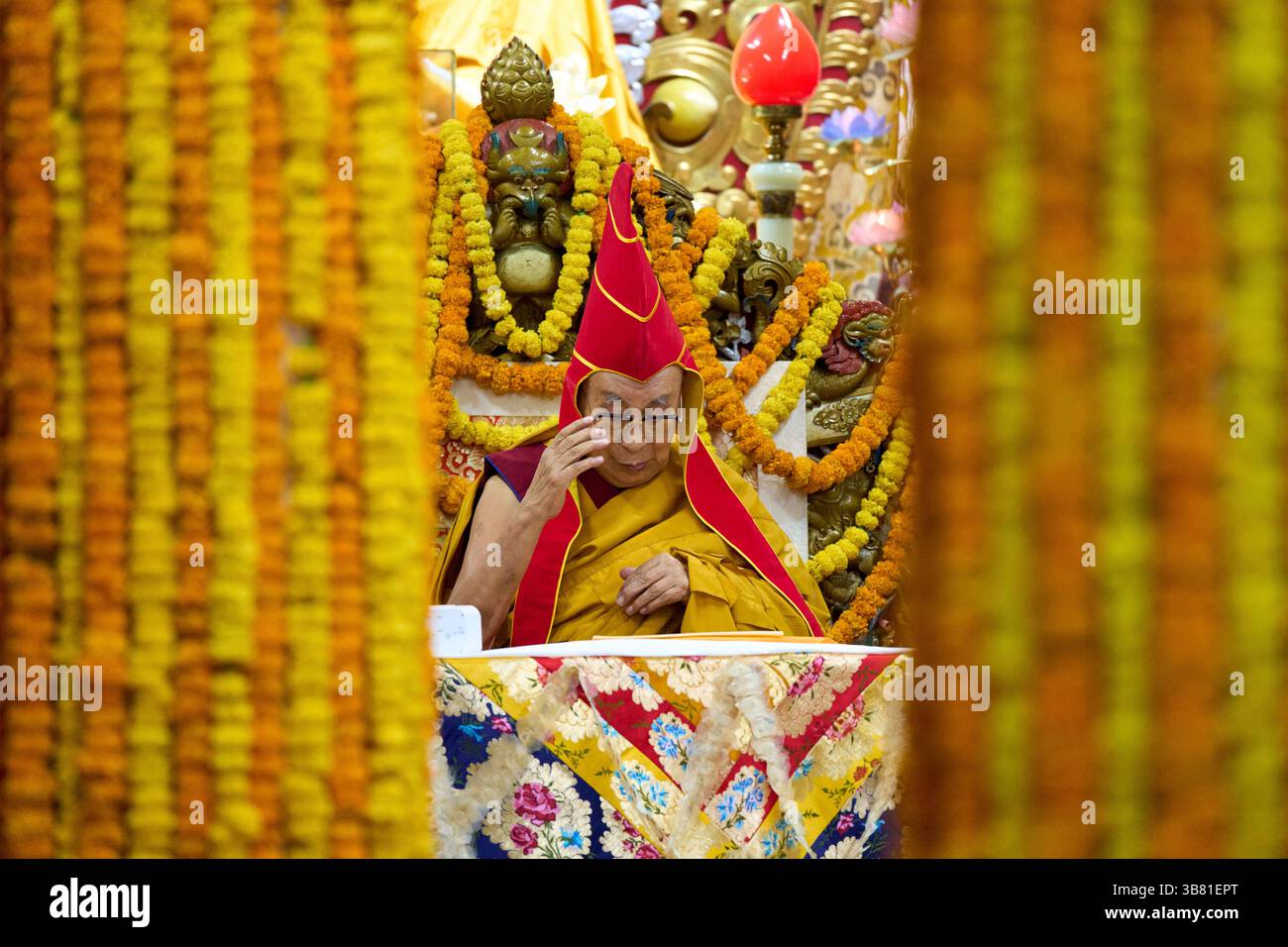 Tibetan spiritual leader the Dalai Lama wears a ceremonial hat at an ...