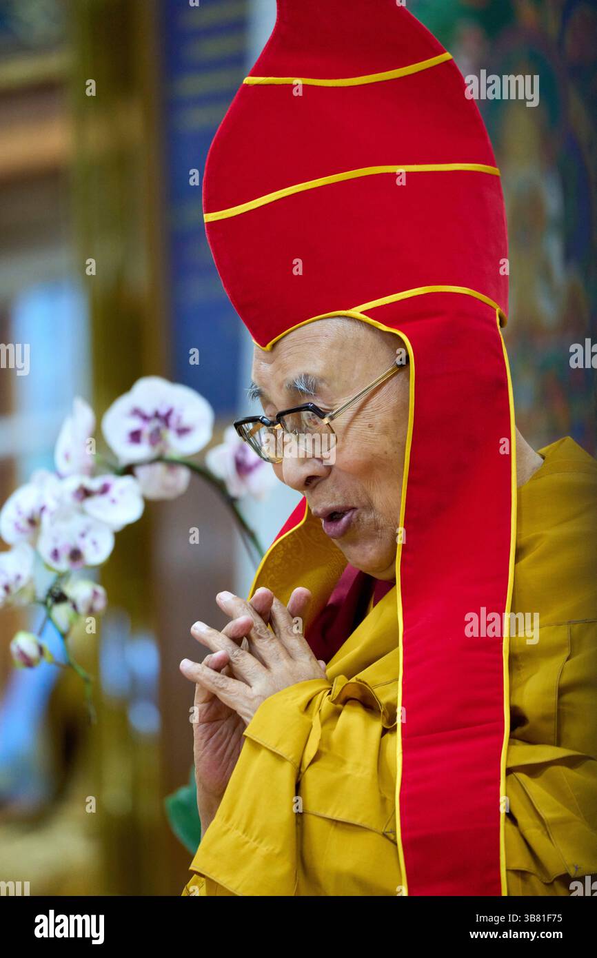 Tibetan spiritual leader the Dalai Lama wears a ceremonial hat at an ...