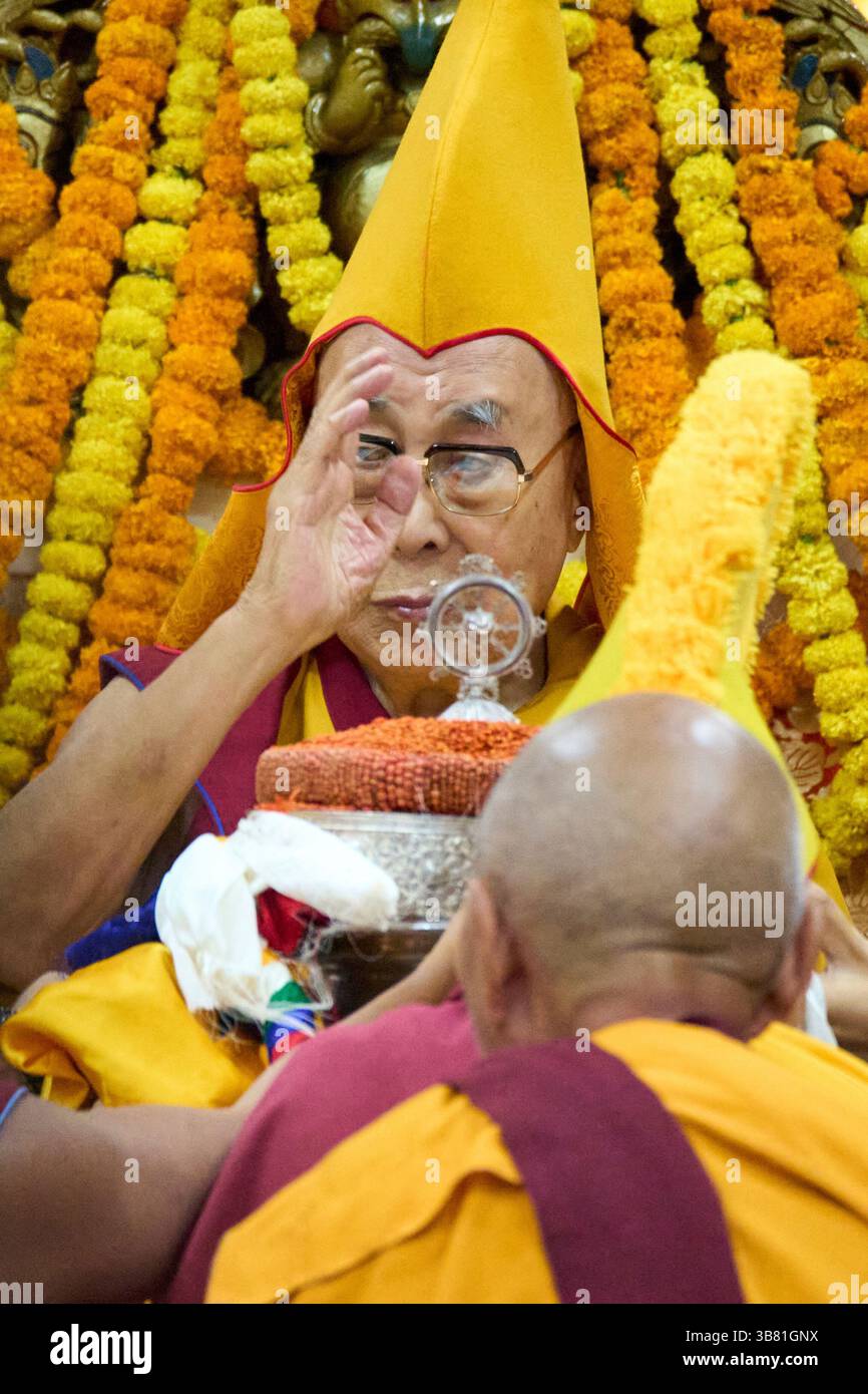 Tibetan spiritual leader the Dalai Lama wears a ceremonial hat as he ...