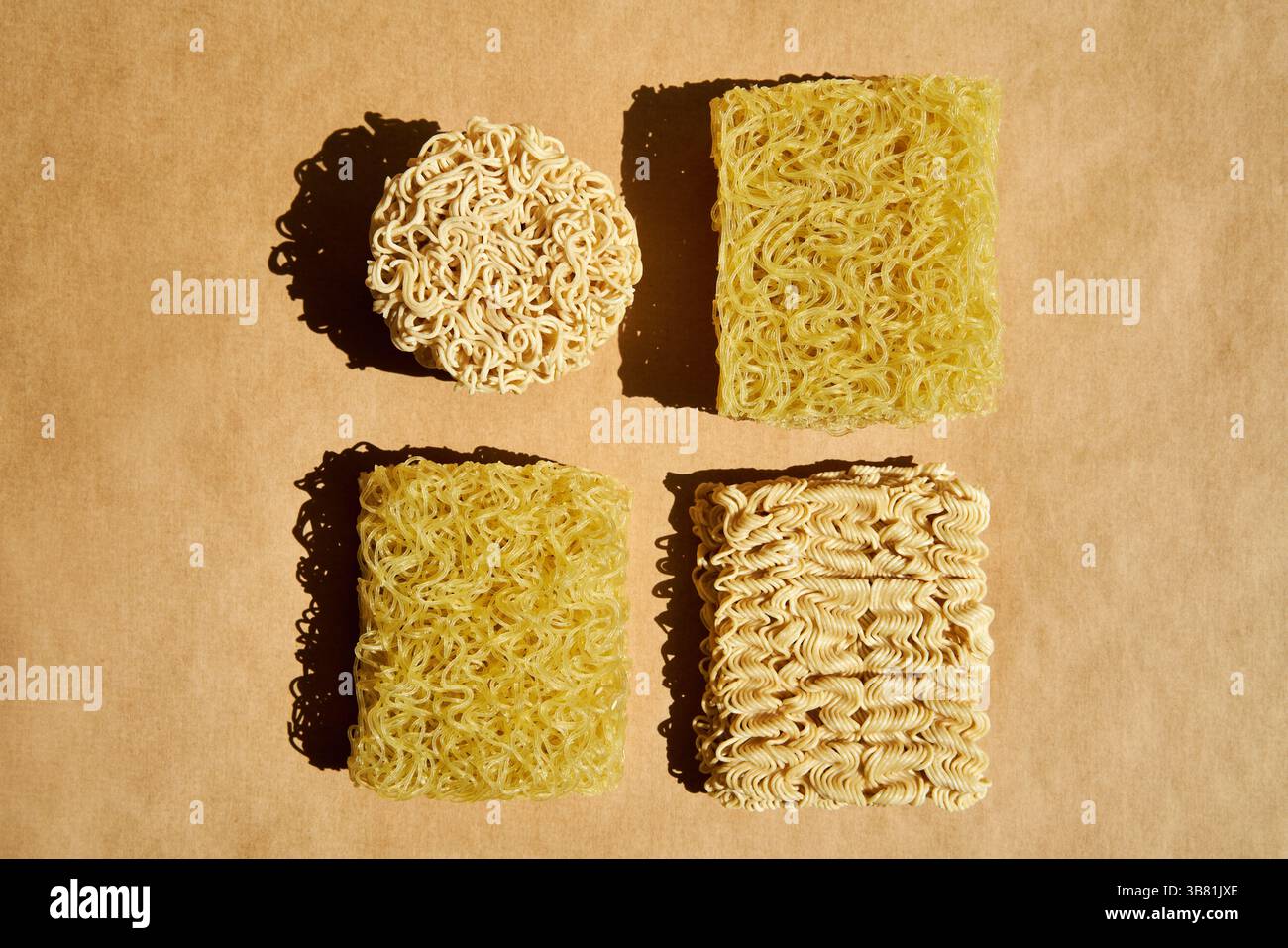 Various dry instant noodle blocks over brown background. Food concept ...