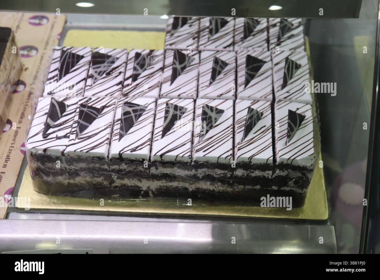 Eye-level shot showcasing rectangular cake pieces. The square portions ...