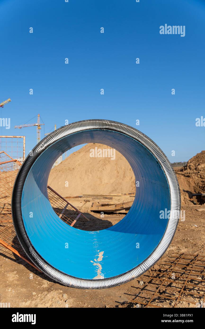 A piece of large corrugated black plastic pipe on construction site ...