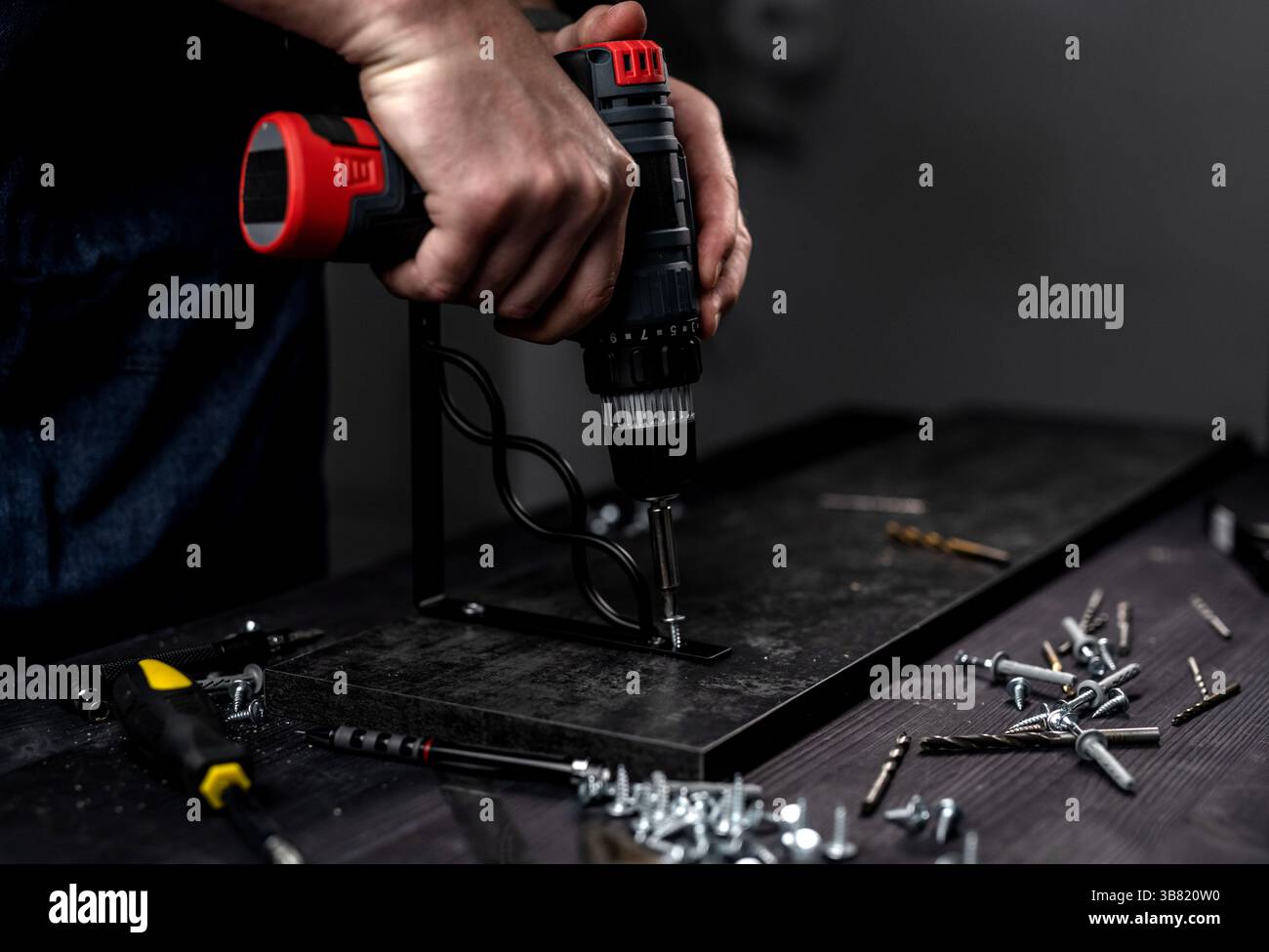 Male handyman screwing bracket hi-res stock photography and images - Alamy