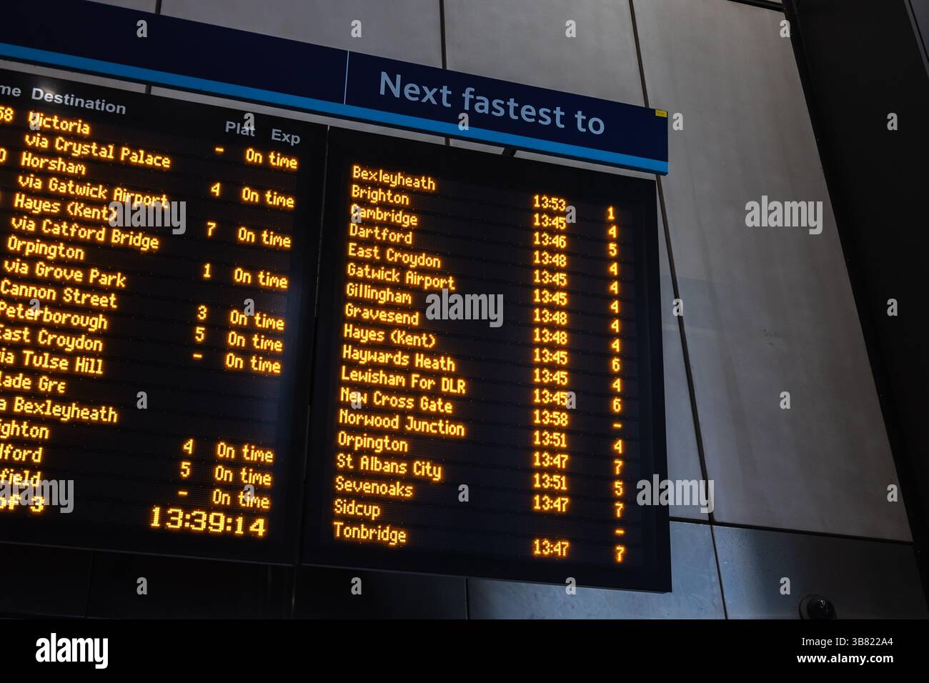 Electronic train schedule display at station showing departure times ...