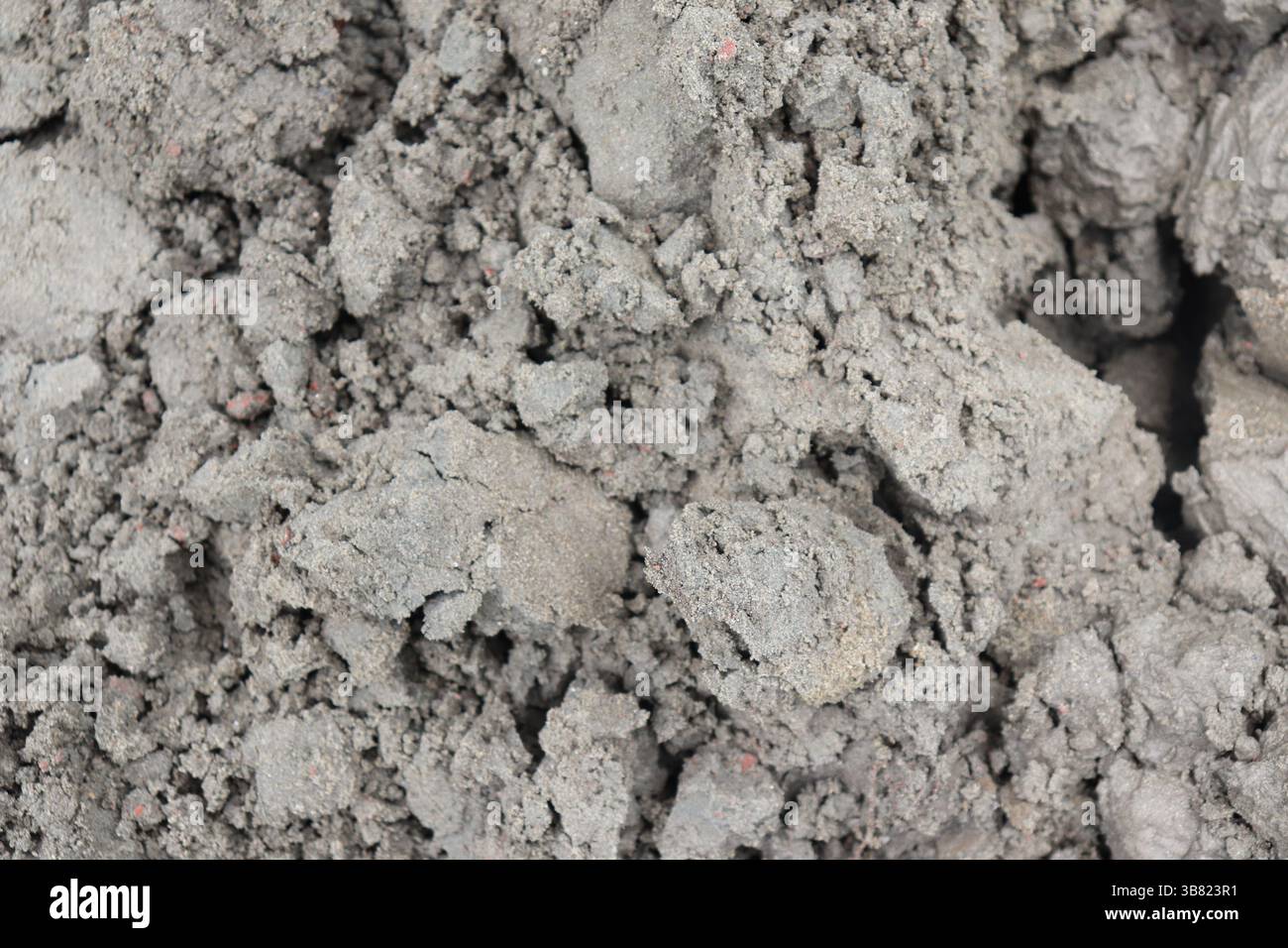 Close up view of a pile of gray soil featuring an uneven and rough ...