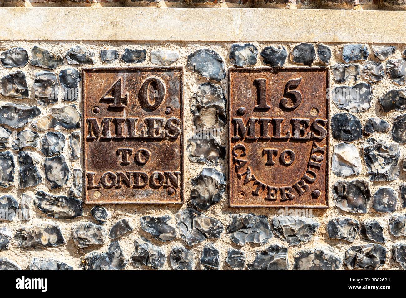 Two metal mile signs showing distances to London and Canterbury from ...