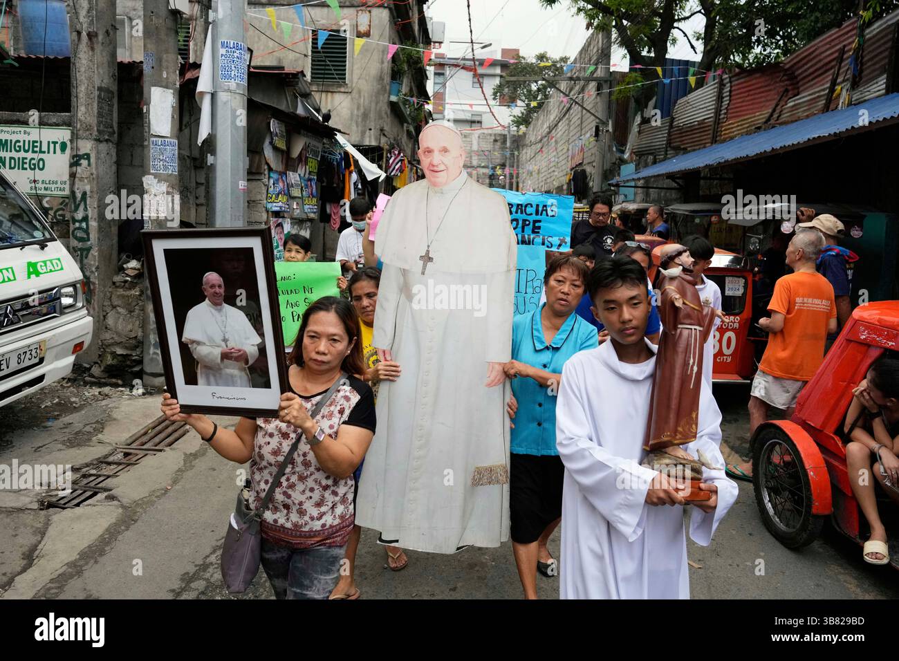A standee and picture of the late Pope Francis is carried by ...