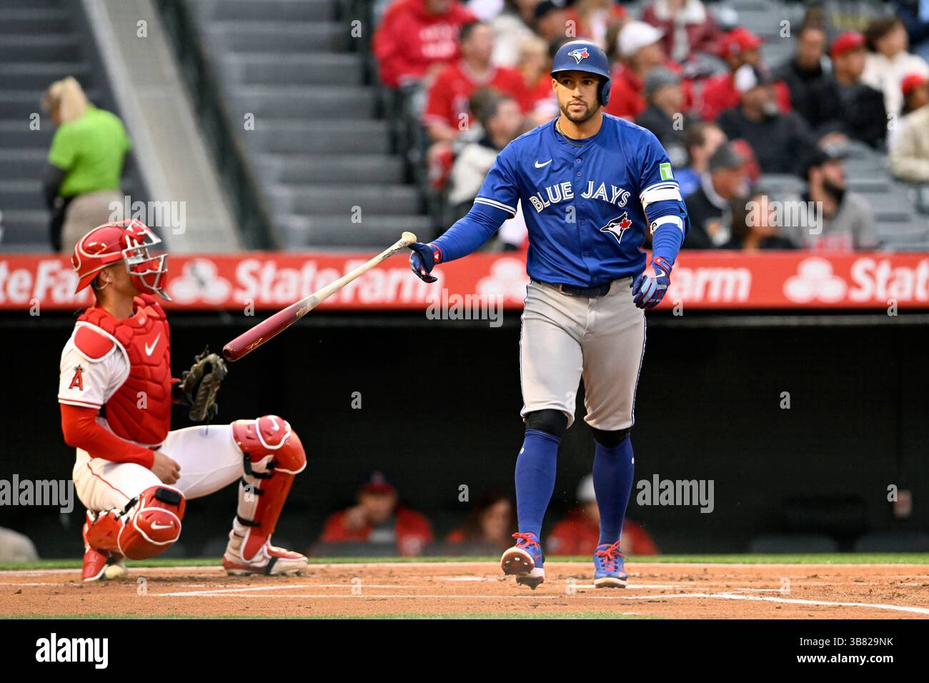 Toronto Blue Jays' George Springer, right, looks over after hitting a ...