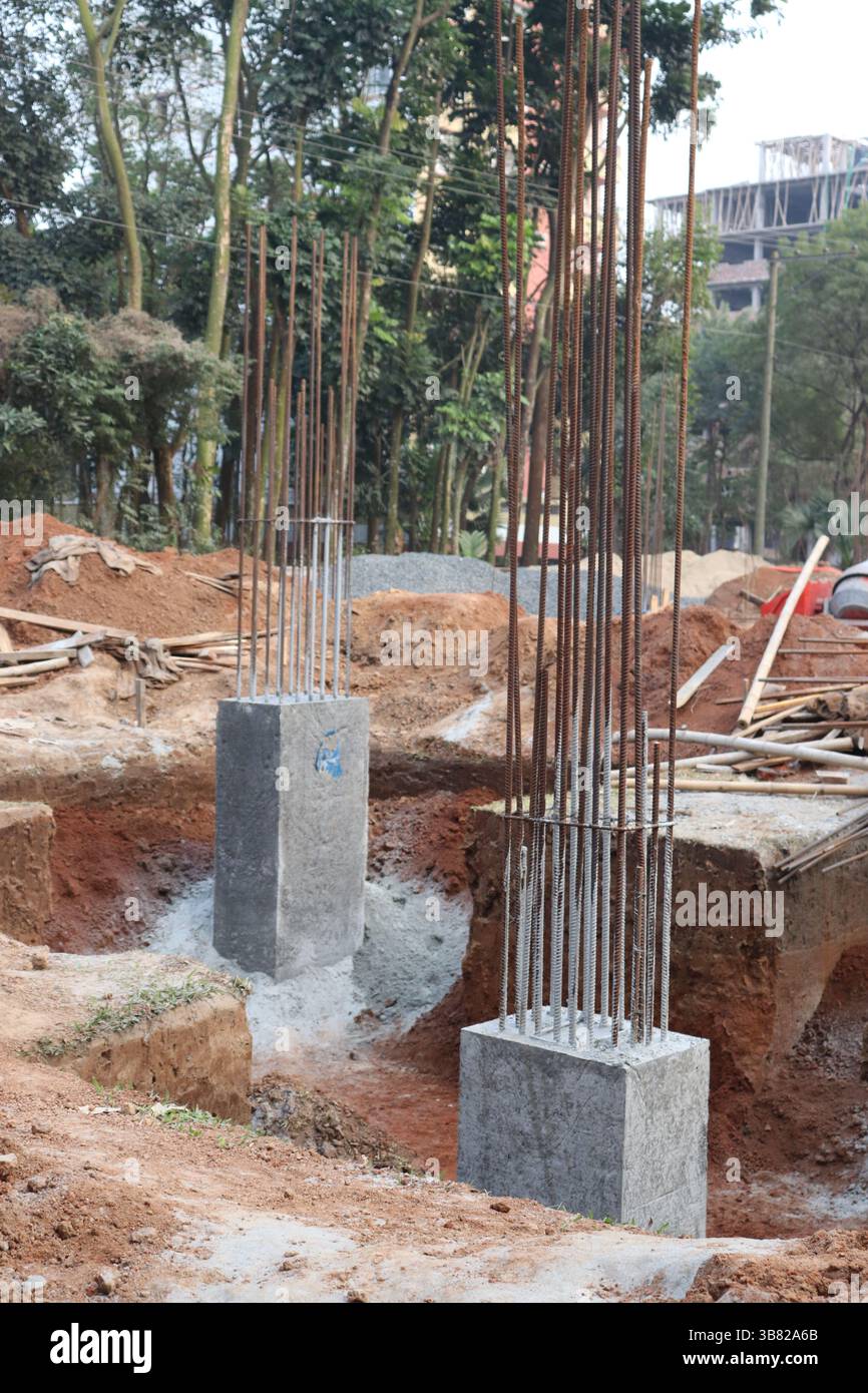 Construction site featuring gray concrete foundation blocks with ...