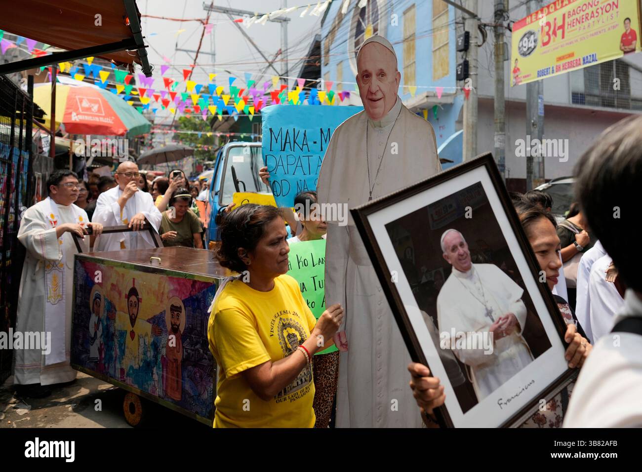 A standee and picture of the late Pope Francis is carried by ...