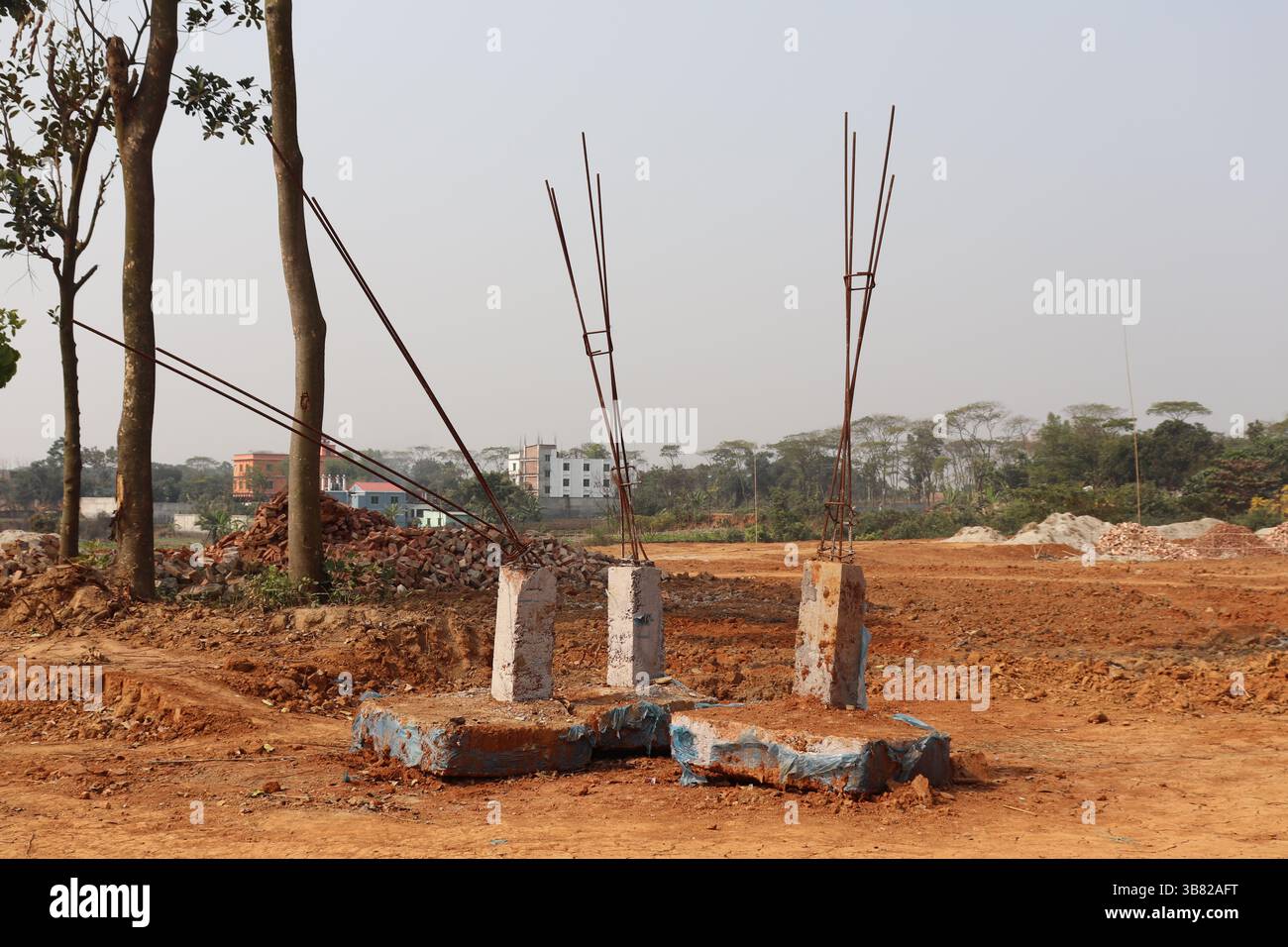 The photo features concrete support structures with rebar, set amid a ...