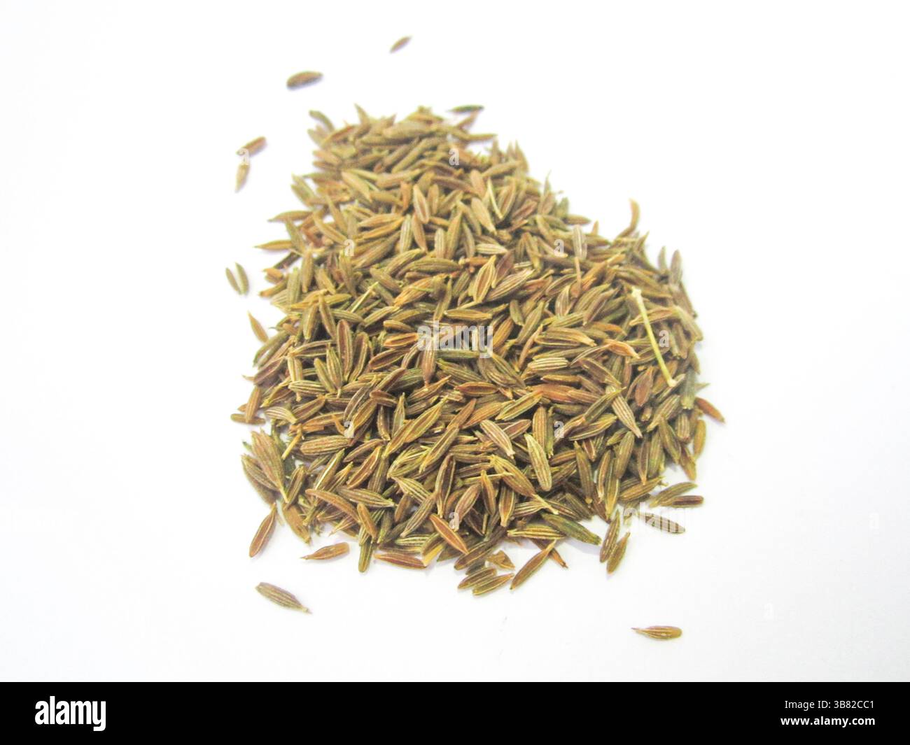 Captured in a close-up, the image features a heap of cumin seeds ...